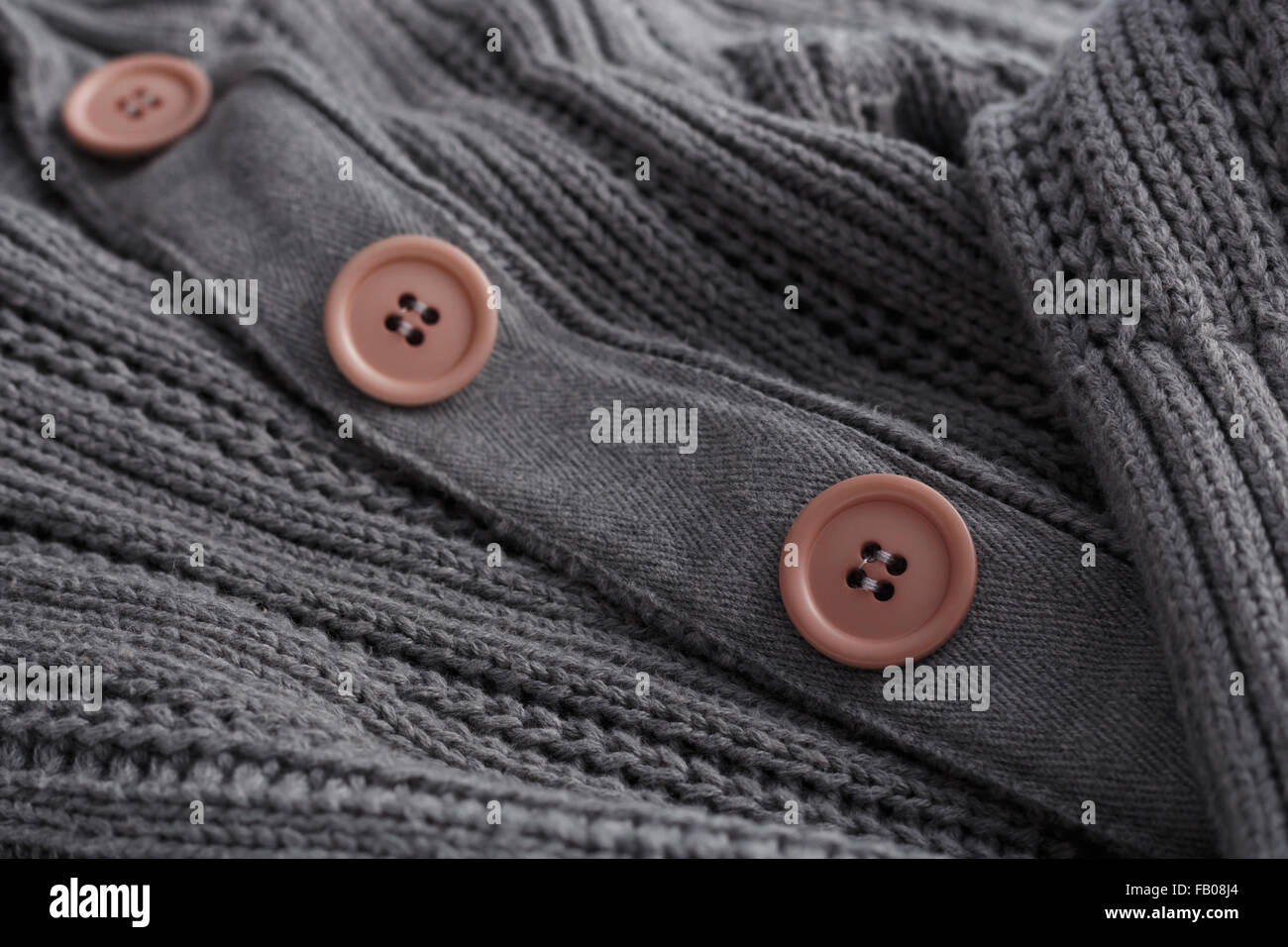 Knit sweater closeup button Stock Photo - Alamy