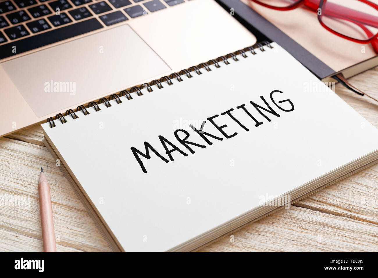 Marketing concept with laptop and notebook on office desk Stock Photo ...