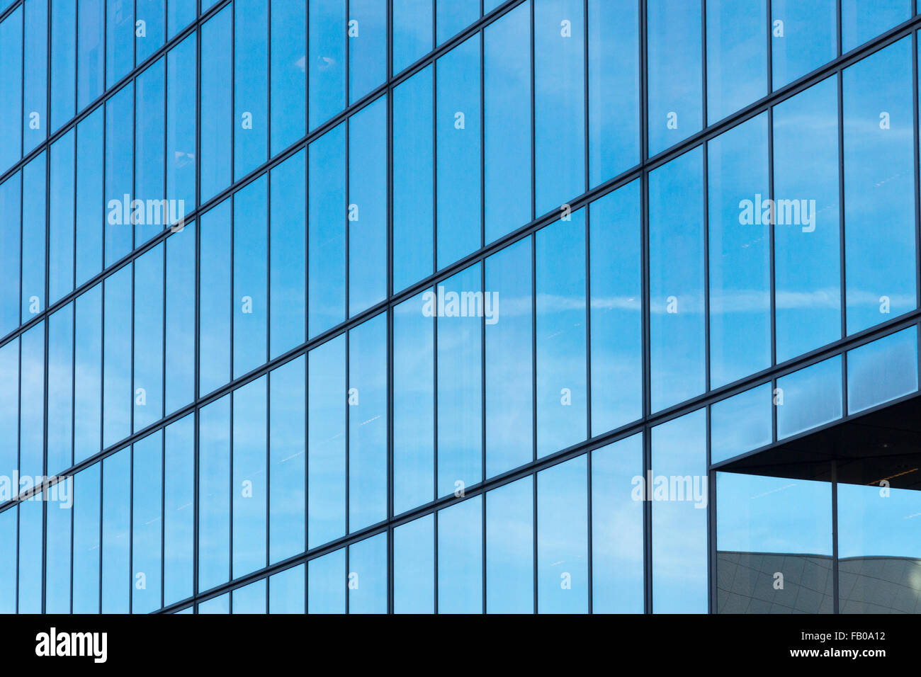 Blue sky reflected in the glass facade of Matrix House on Basing View ...