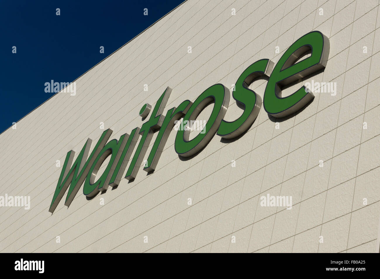 Logo and green lettering on the modern facade of Waitrose supermarket ...
