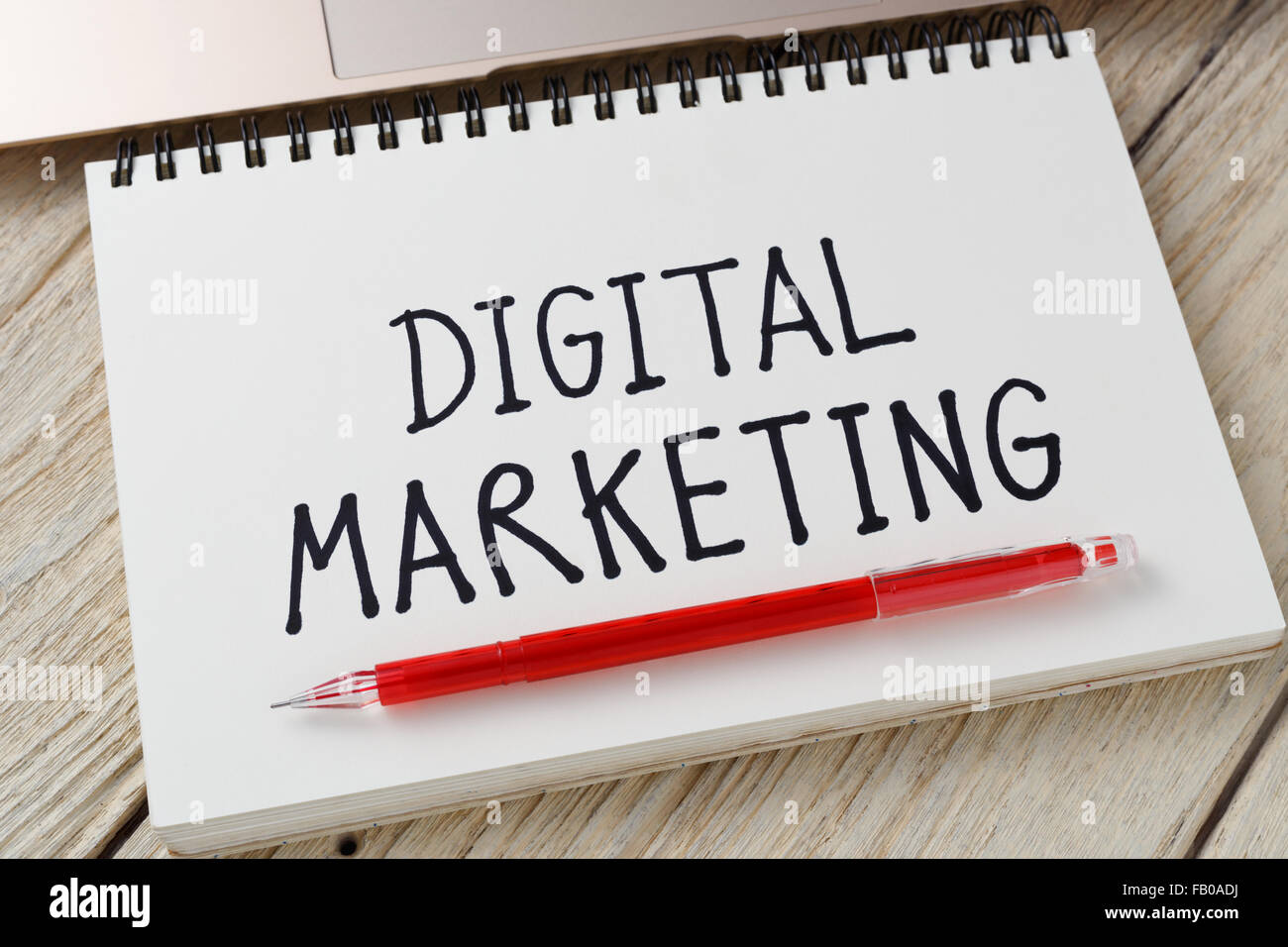 Digital marketing handwriting note closeup with red pen on office desk ...