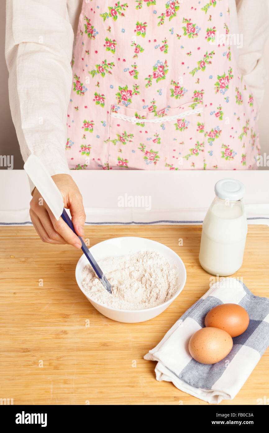 Woman mixing flour with baking ingredients for muffin Stock Photo - Alamy