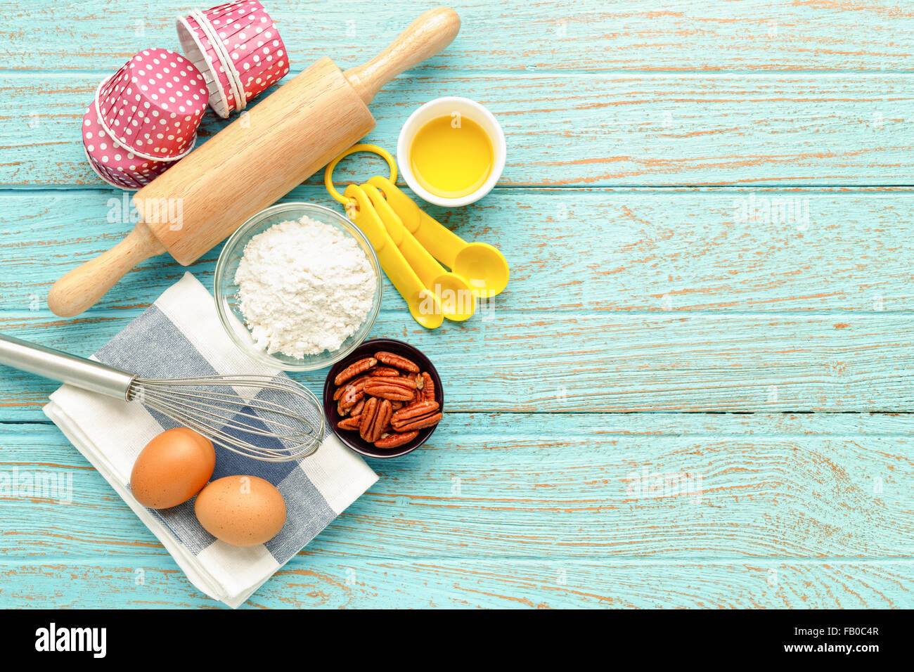 Baking background with ingredients flour eggs pecan nut olive oil and ...