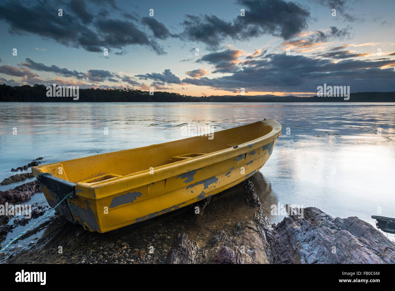 Yellow rowing boat on the shore of a lake in Bermagui, Australia at ...