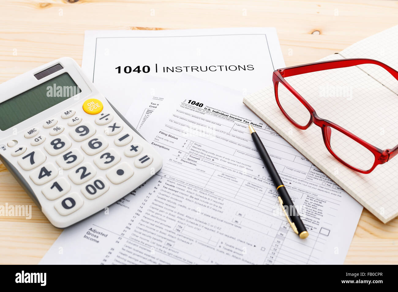 Income tax income return form and instruction with calculator and pen ...