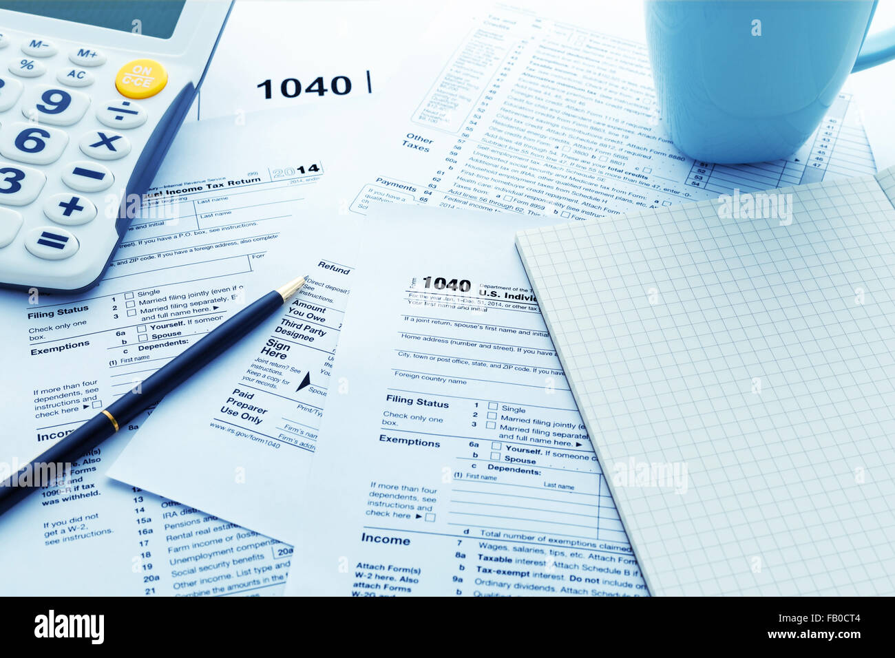 Income tax return form with calculator and pen Stock Photo - Alamy