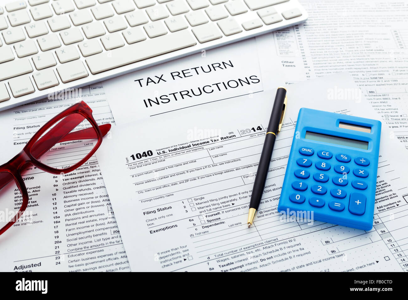 Tax return form with computer keyboard and calculator Stock Photo - Alamy