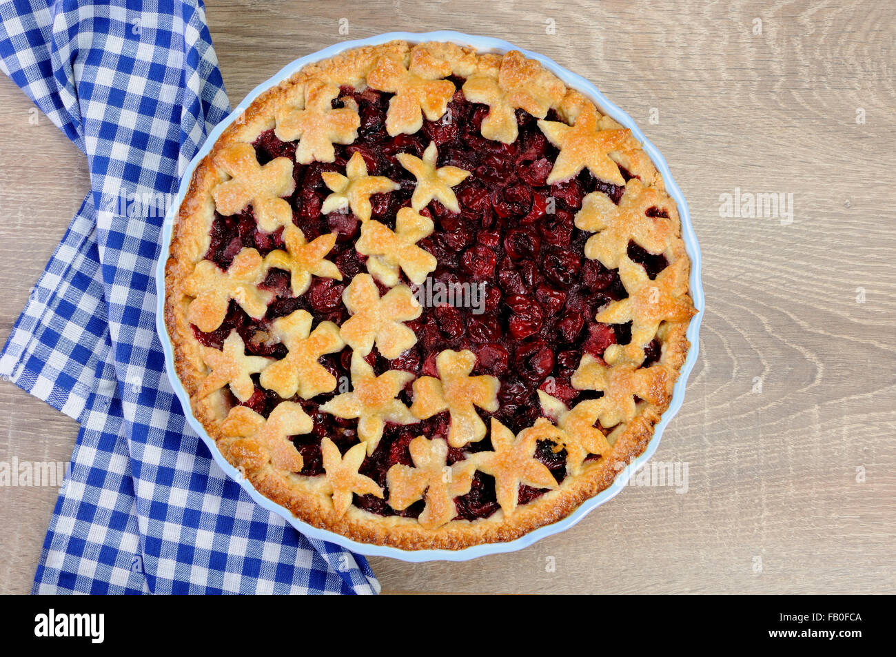 pie with cherry filling decorated flowers and petals Stock Photo - Alamy