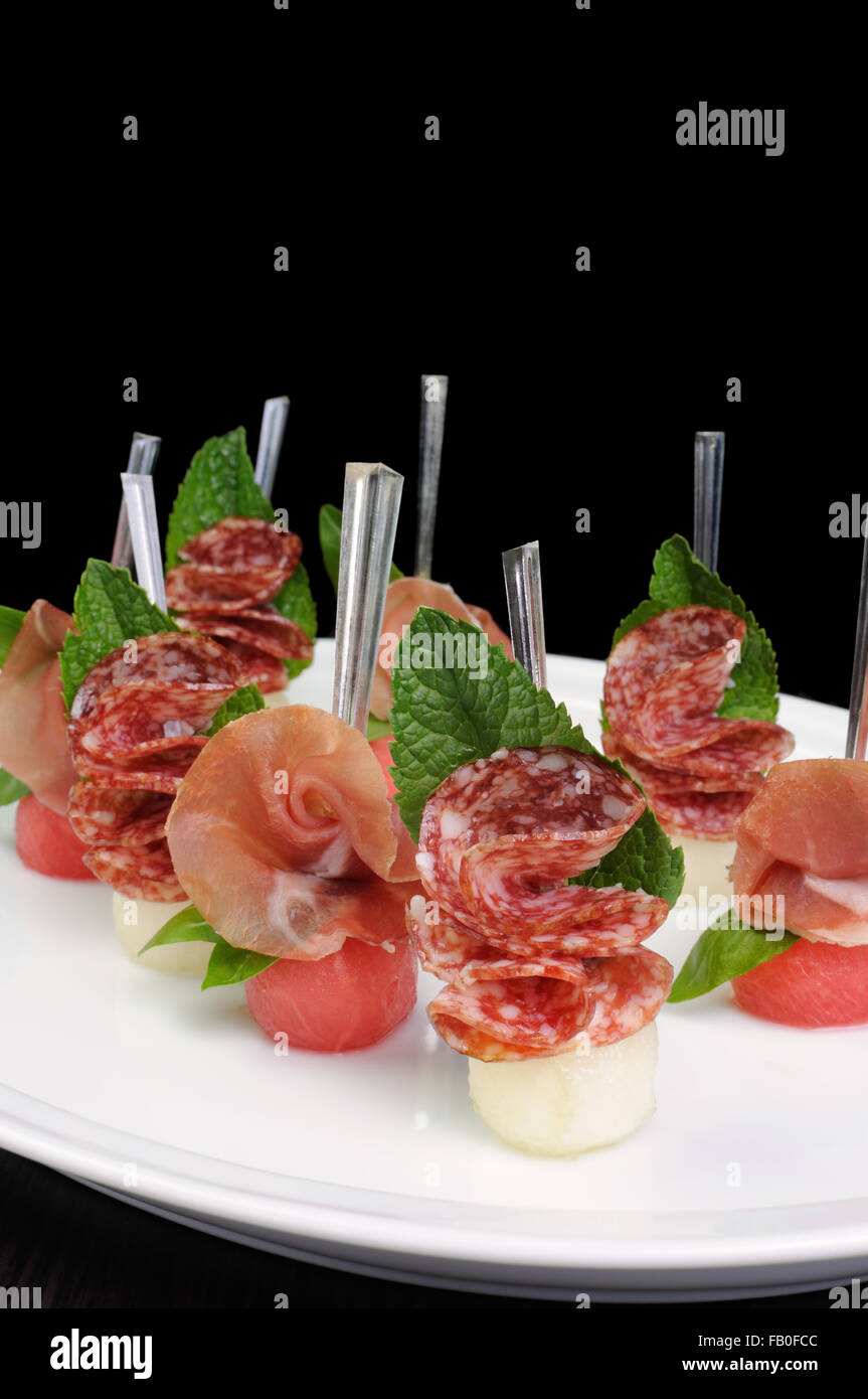 Canape of watermelon balls with a melon with gammon and salami Stock ...