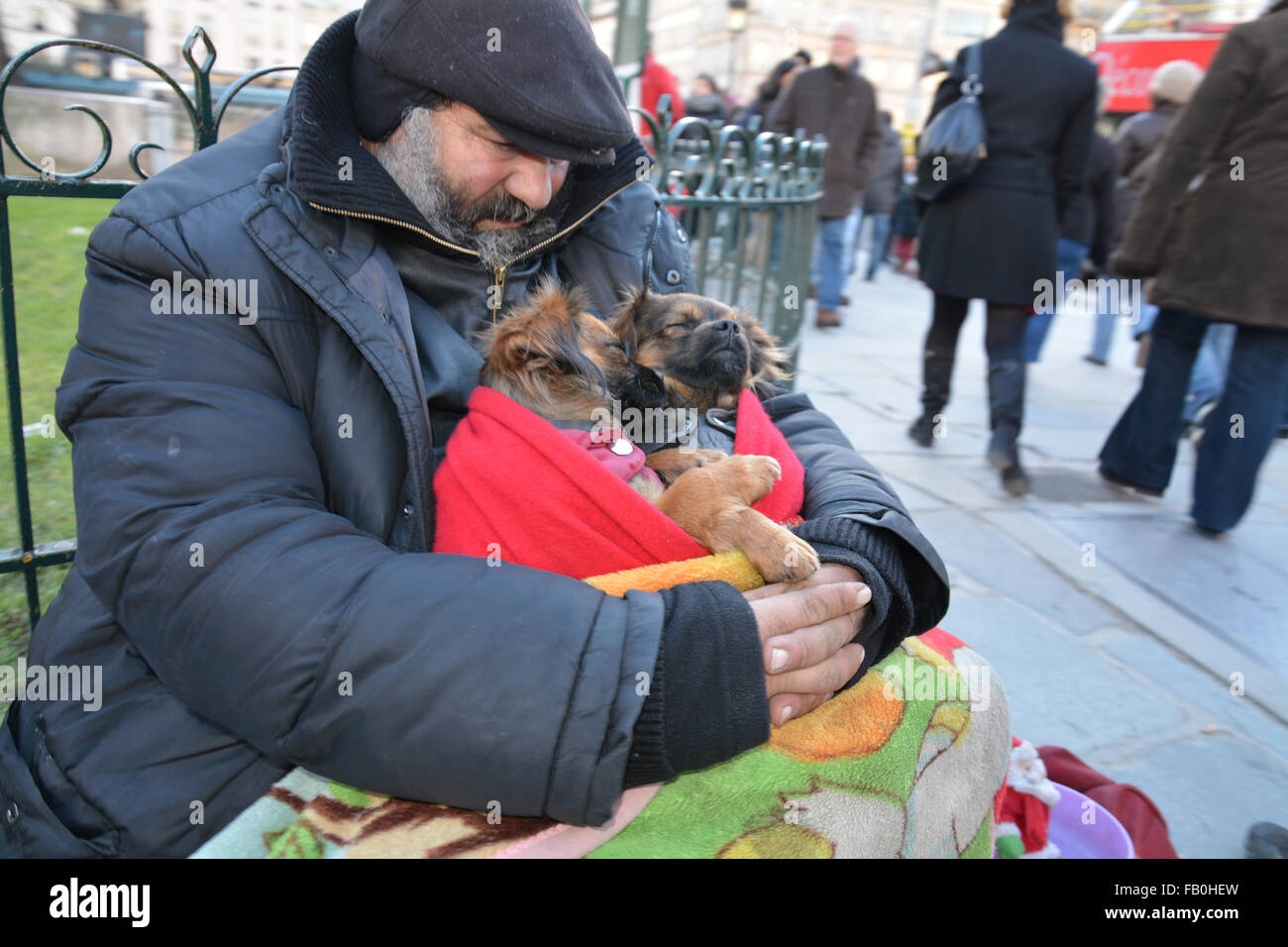 A homeless man at the steps of Notre Dame Cathedral, Paris with two ...