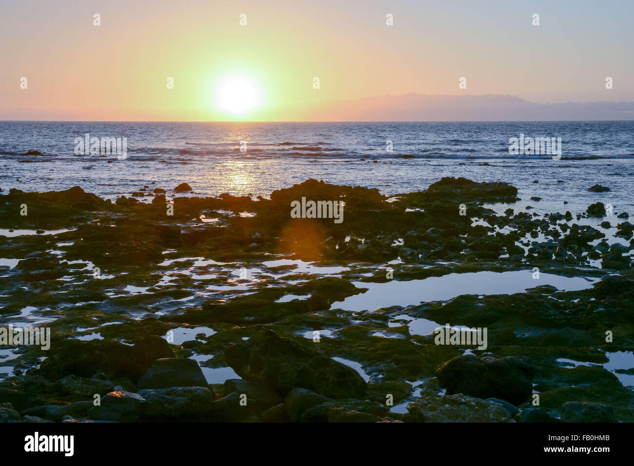 The Sun Setting in the Sea Stock Photo - Alamy