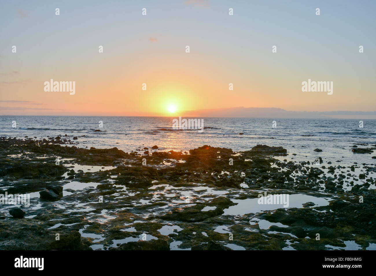 The Sun Setting in the Sea Stock Photo - Alamy