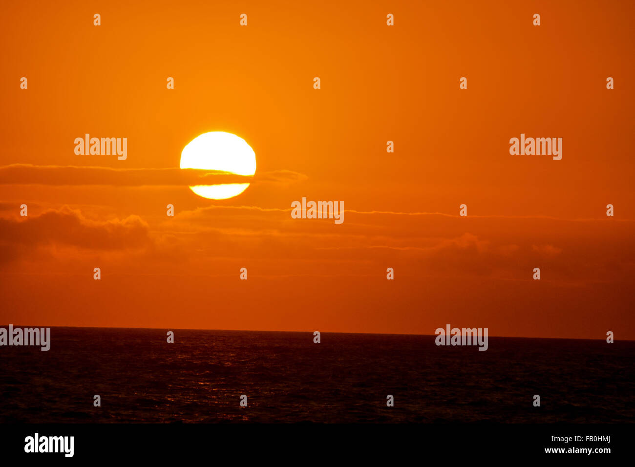 The Sun Setting in the Sea Stock Photo - Alamy