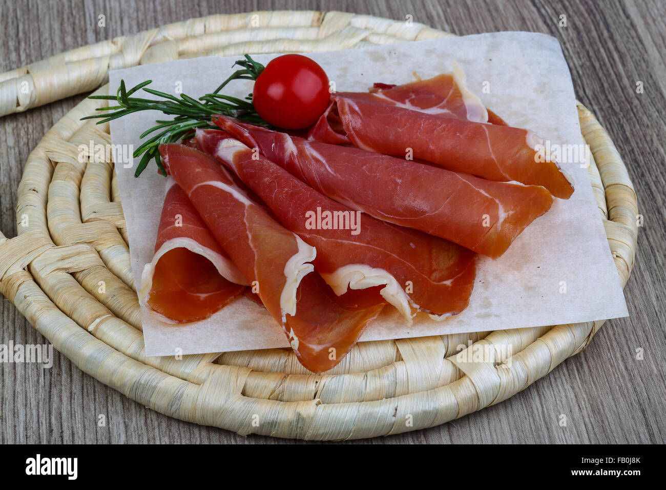 Spanish traditional snack - Jamon with tomato and rosemary Stock Photo ...