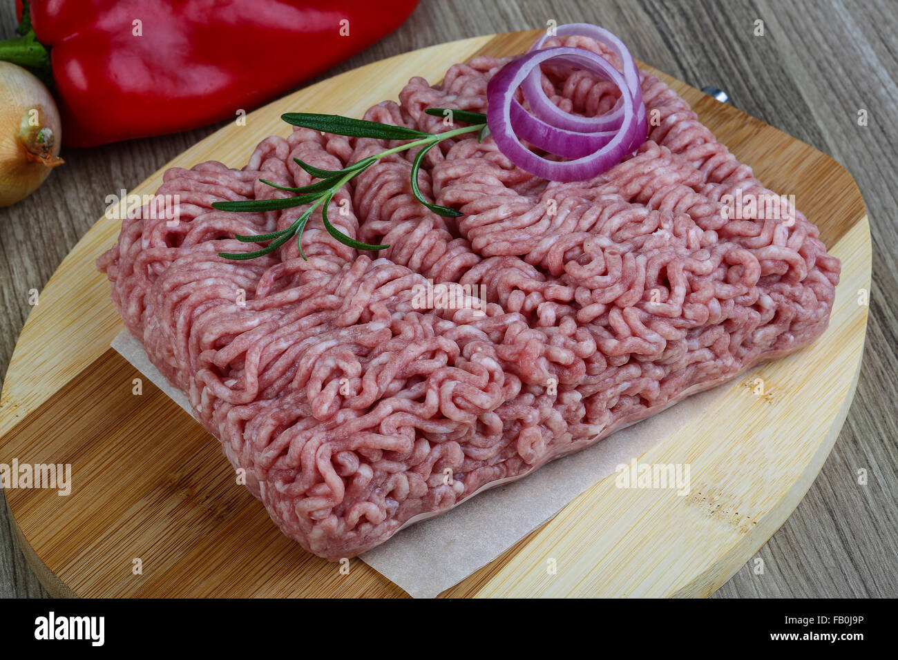Raw minced pork meat with onion and rosemary ready for cooking Stock ...
