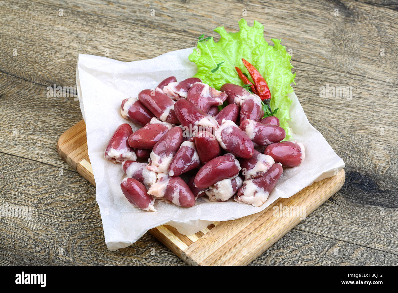 Raw chicken hearts ready for cooking on the wood background Stock Photo ...