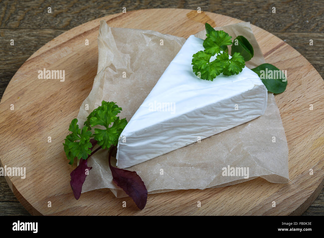 Soft brie cheese served parsley leaves on wooden background Stock Photo ...