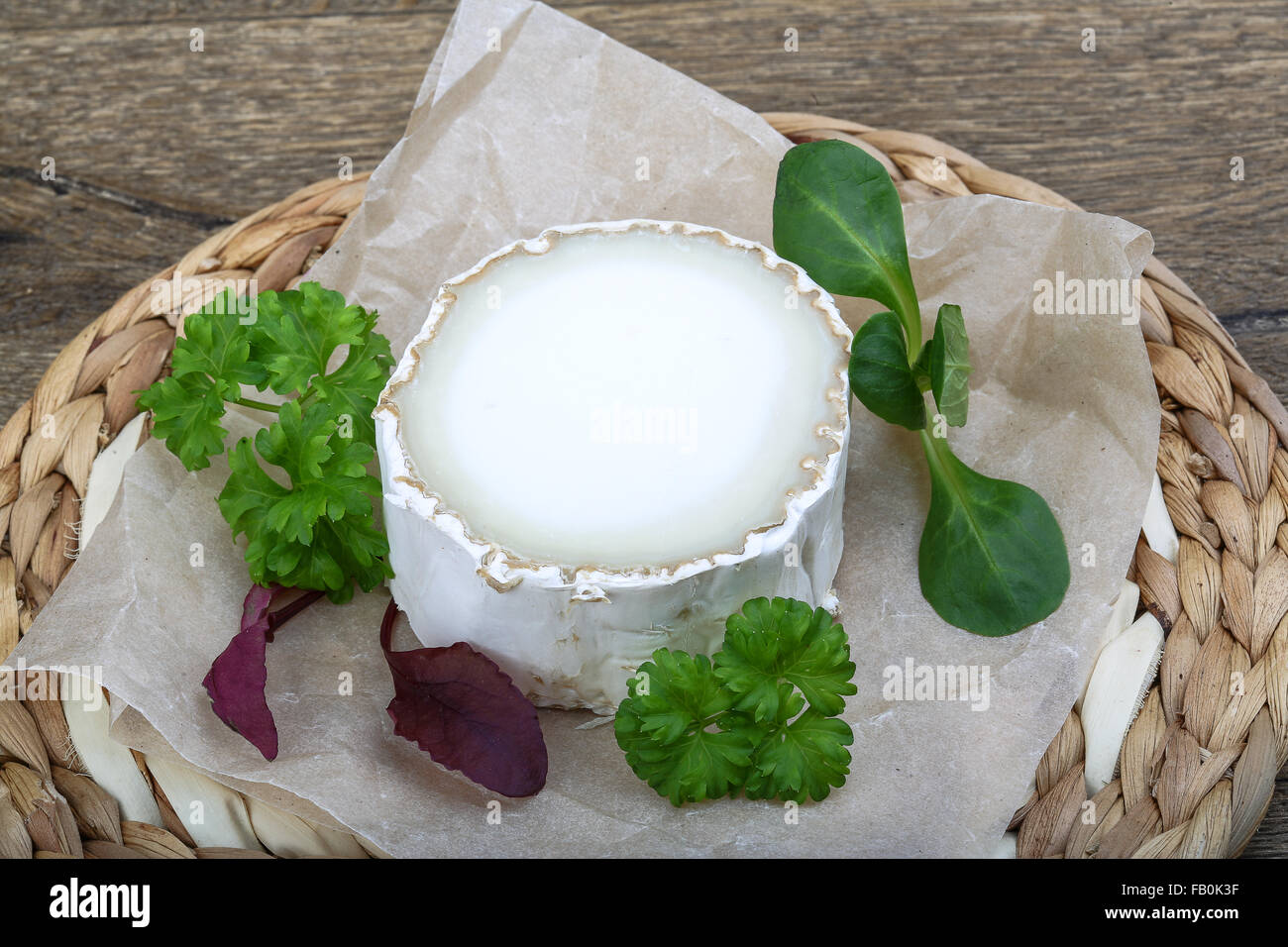 Goat cheese with white mold served parsley leaves Stock Photo - Alamy