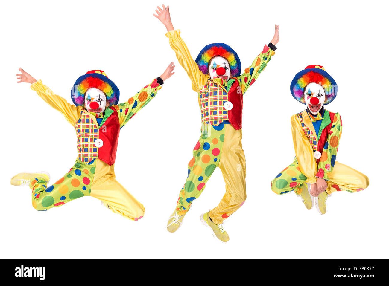Young girl with clown costume jumping isolated in white Stock Photo - Alamy