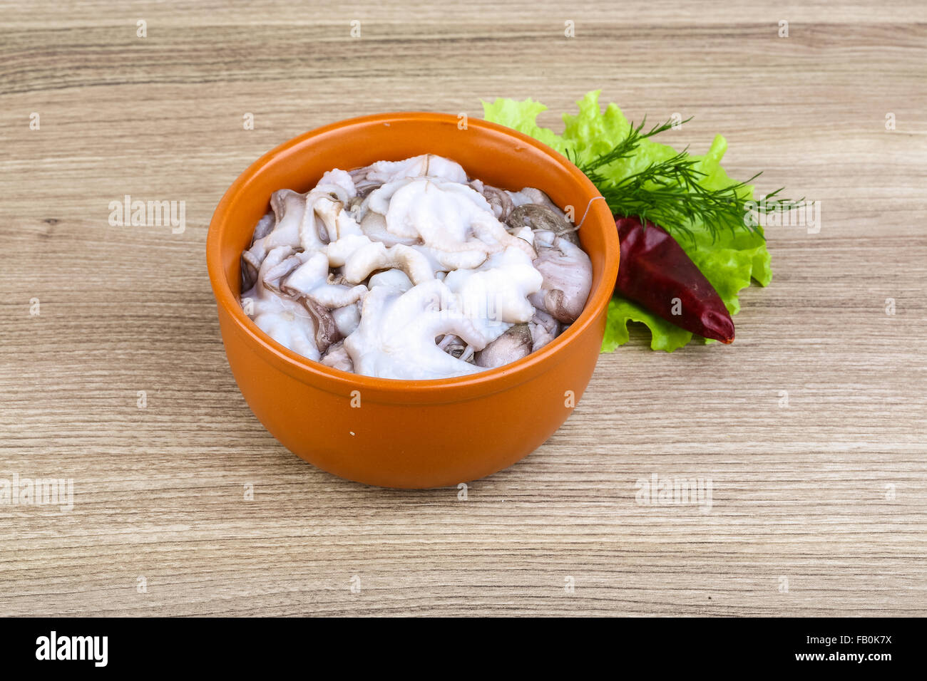 Raw baby octopus in the bowl ready for cooking Stock Photo - Alamy
