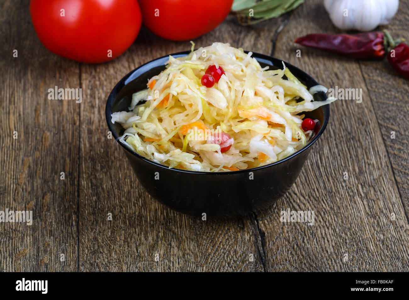 Fermented cabbage - Sauerkraut with herbs and spices on the wood ...