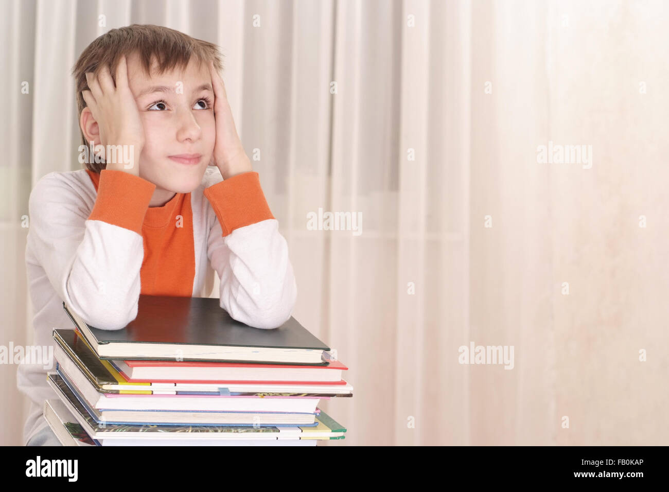 sad boy doing homework on a white background Stock Photo - Alamy