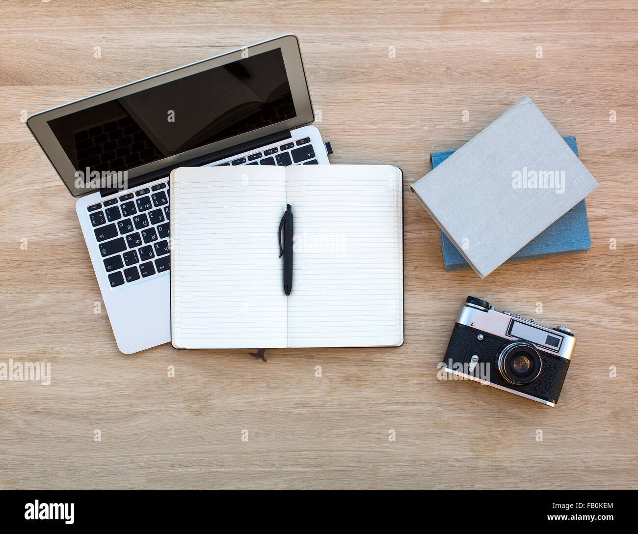 Laptop, Notepad, pen, film camera and books Stock Photo - Alamy