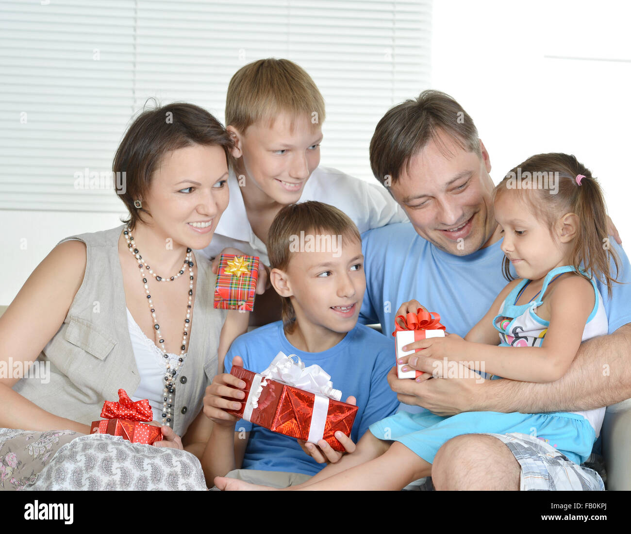Friendly family with gifts Stock Photo - Alamy