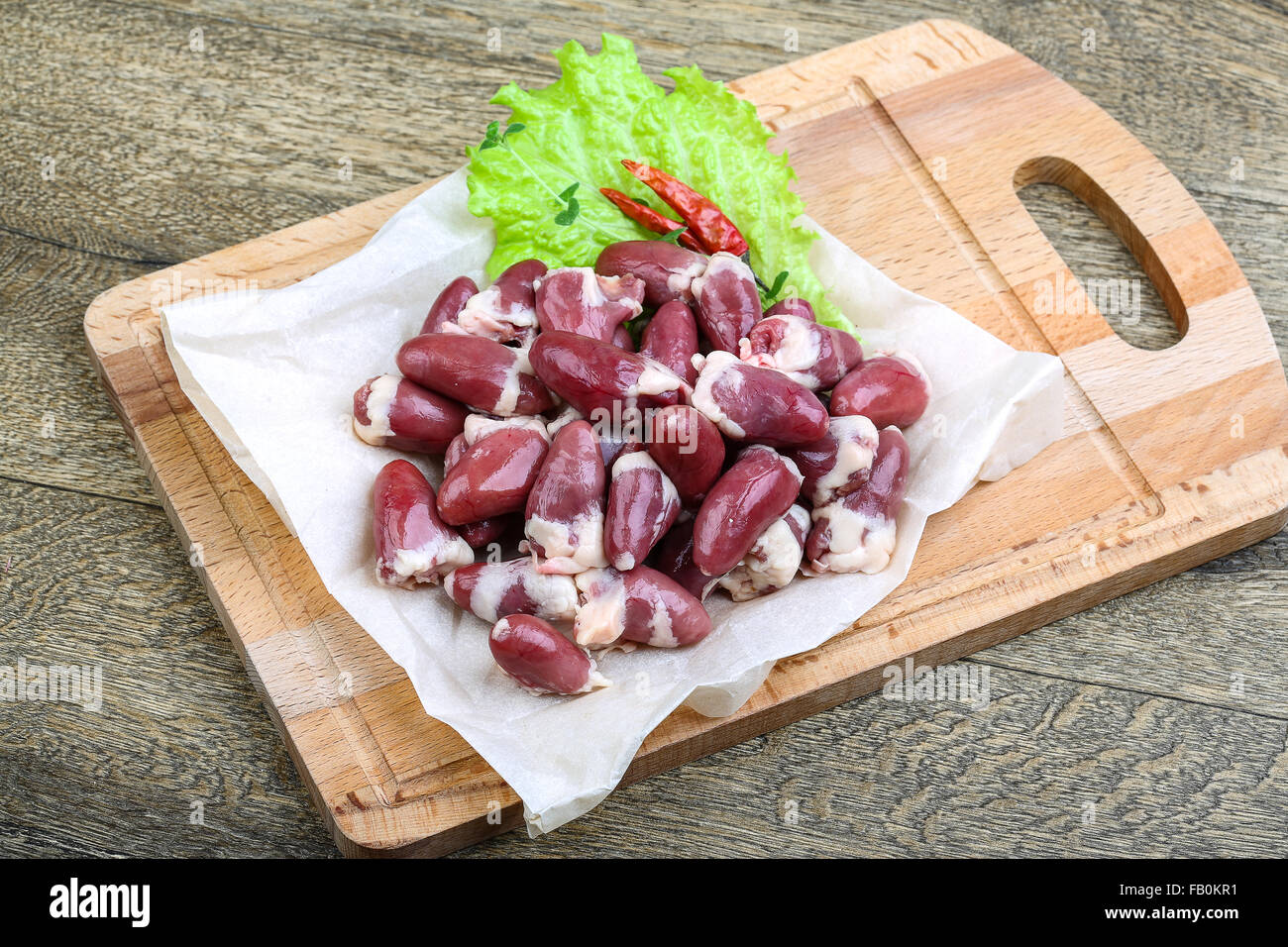 Raw chicken hearts ready for cooking on the wood background Stock Photo ...