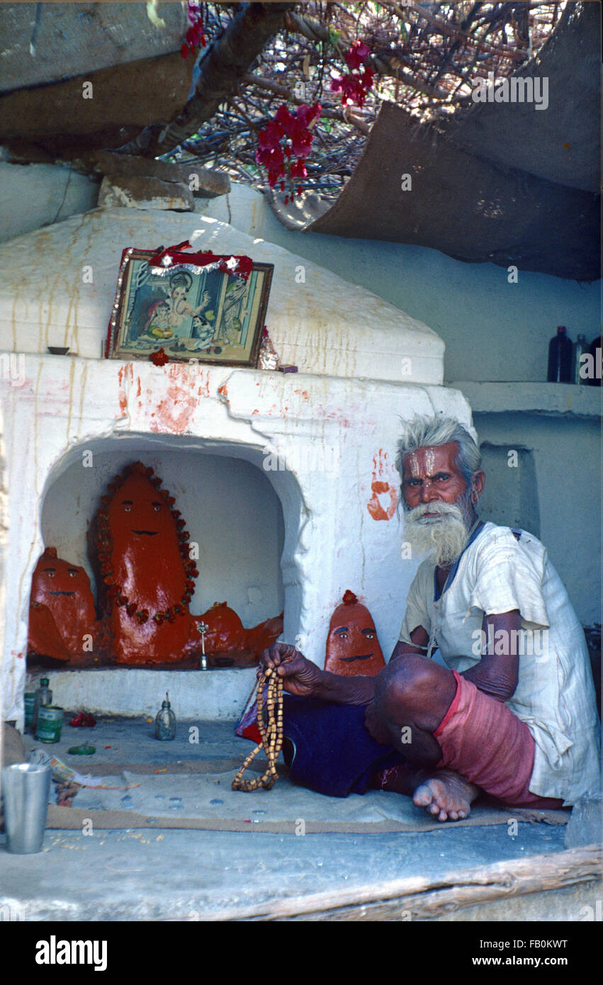 Hindu Sadhu or India Holy Man Meditates in a Small Roadside Shrine on ...