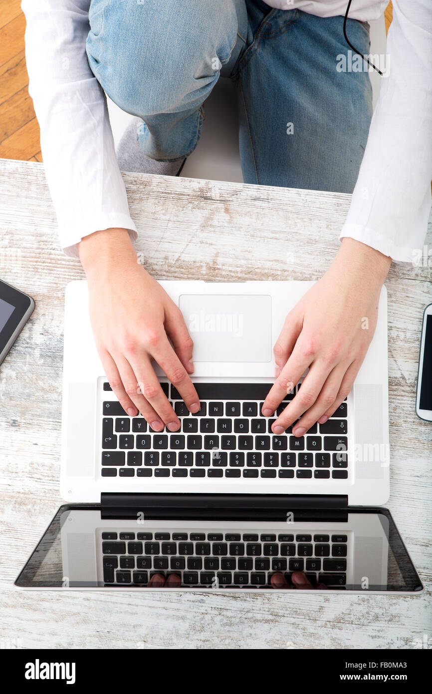 A young man using his laptop computer at home Stock Photo - Alamy