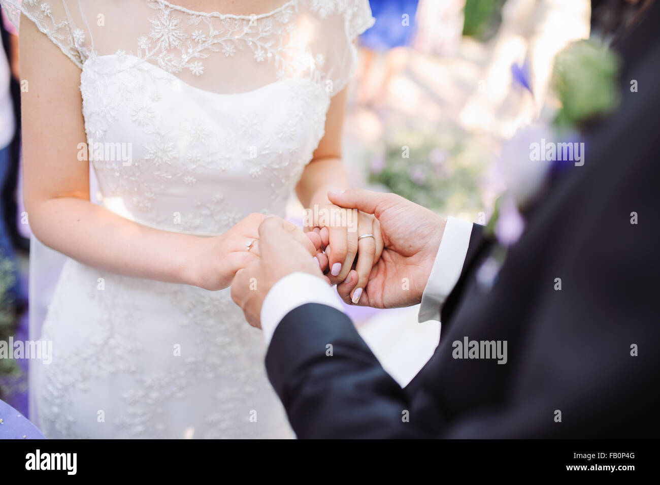 Two hands holding rings hi-res stock photography and images - Alamy