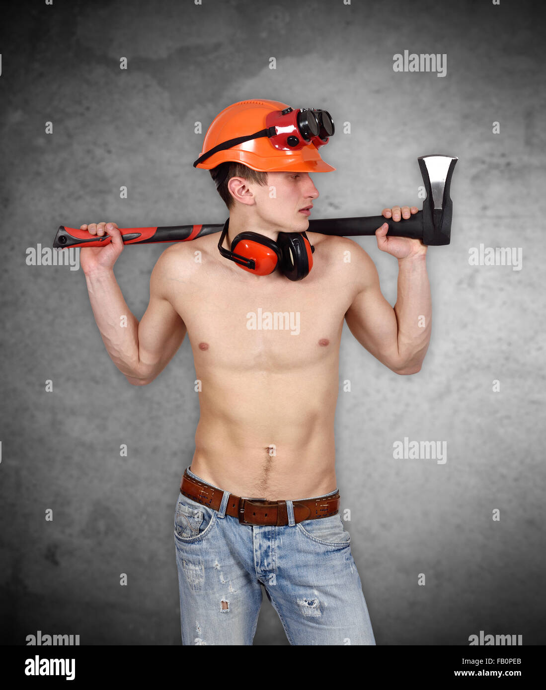 handyman with ax on a gray background Stock Photo - Alamy