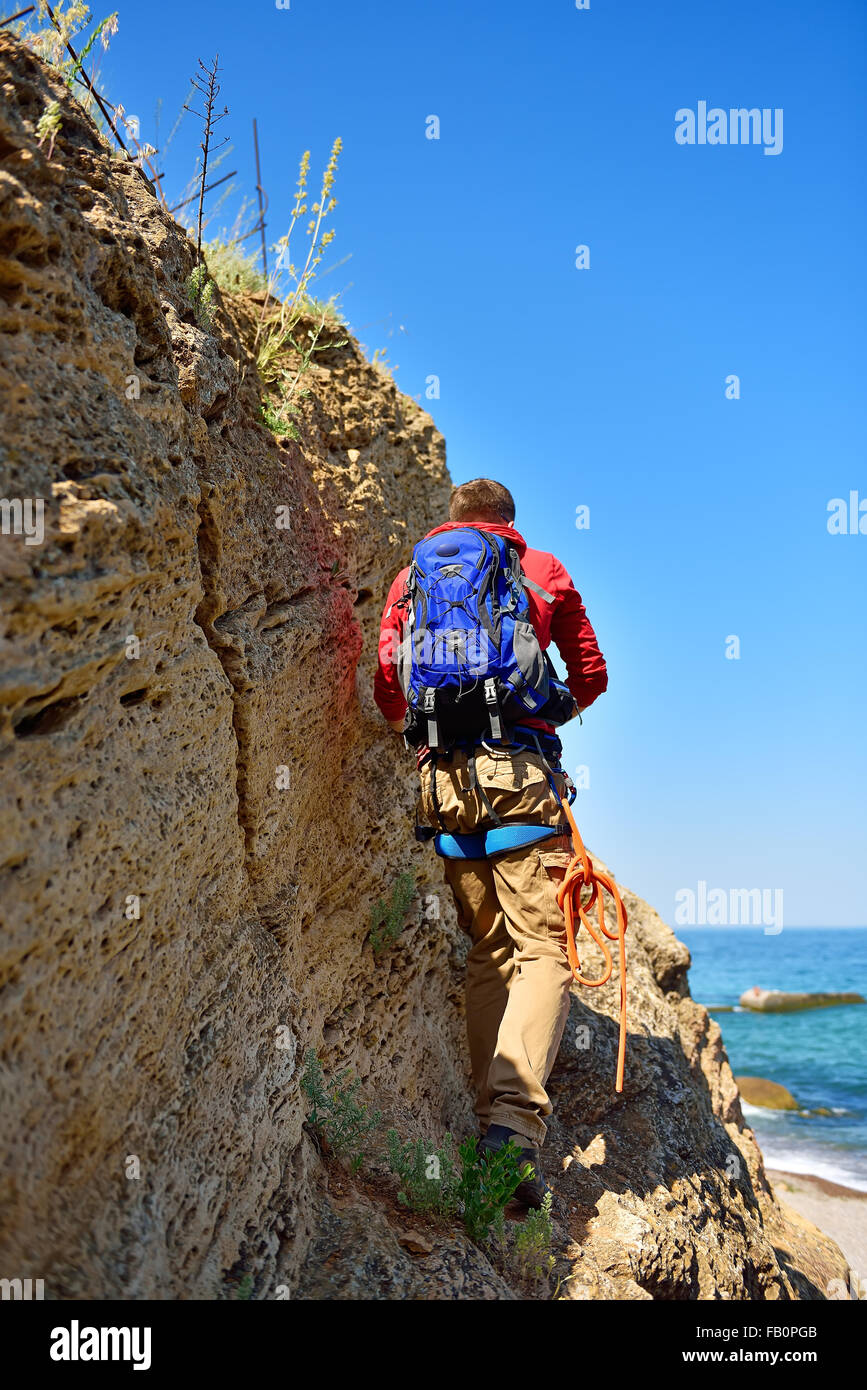 tourist with backpack walking on the cliff Stock Photo - Alamy