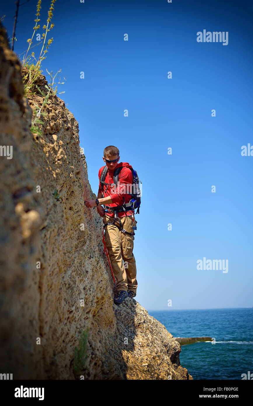 tourist walking on the cliff on a blue sky background Stock Photo - Alamy