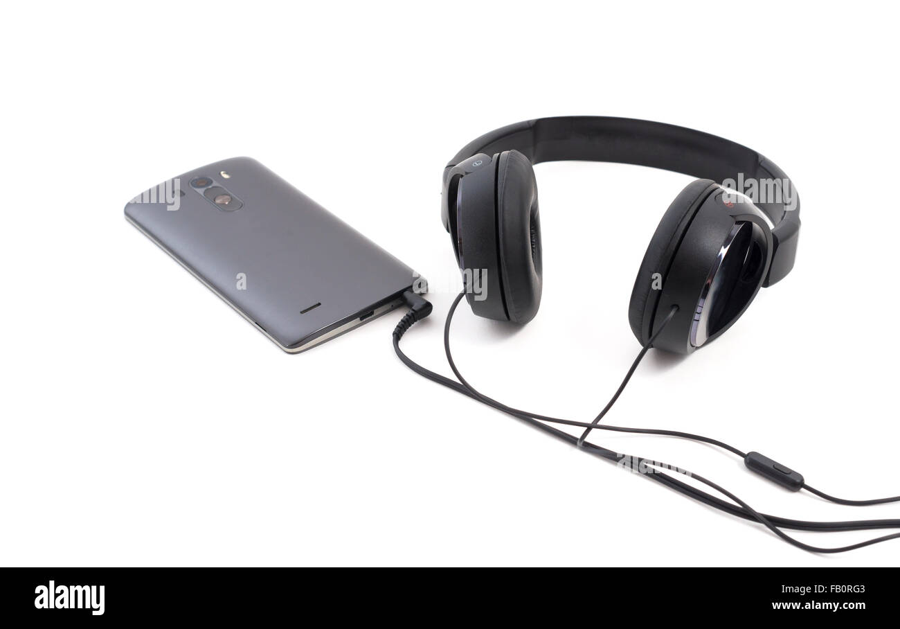Headphones and smartphone. Isolated on white background Stock Photo - Alamy