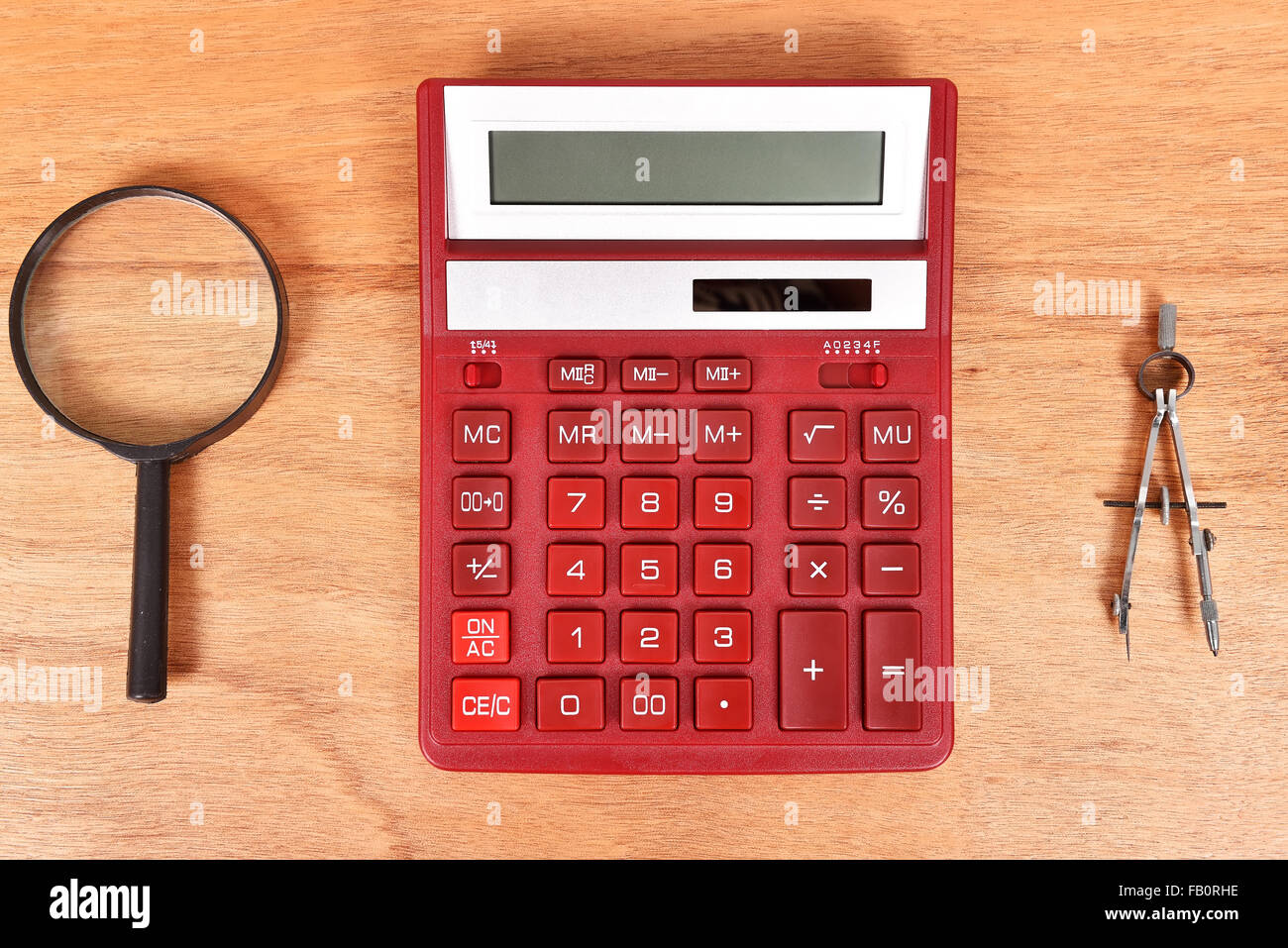 Modern Red Calculator, magnifying glass and compass Stock Photo - Alamy
