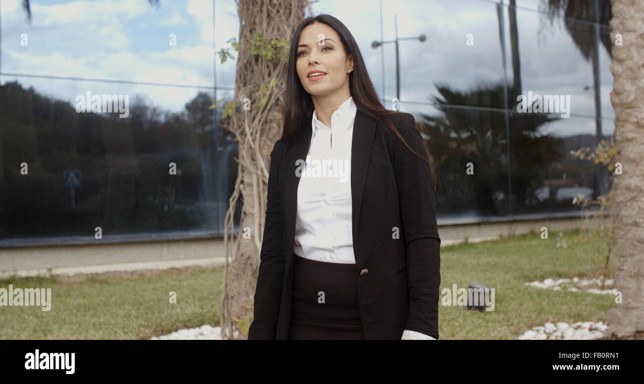 Young professional woman standing waiting Stock Photo - Alamy