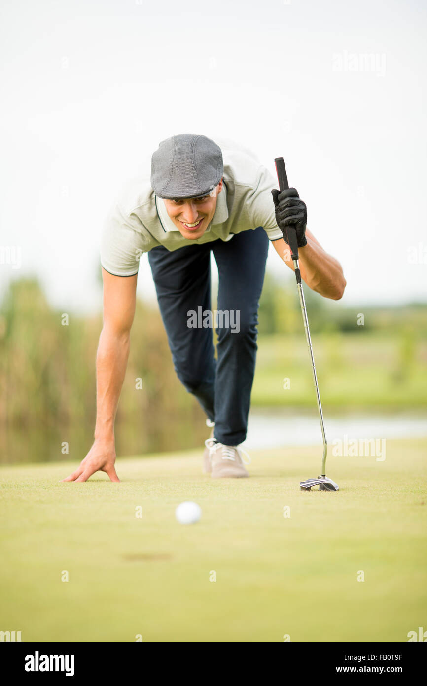 Young man playing golf Stock Photo - Alamy