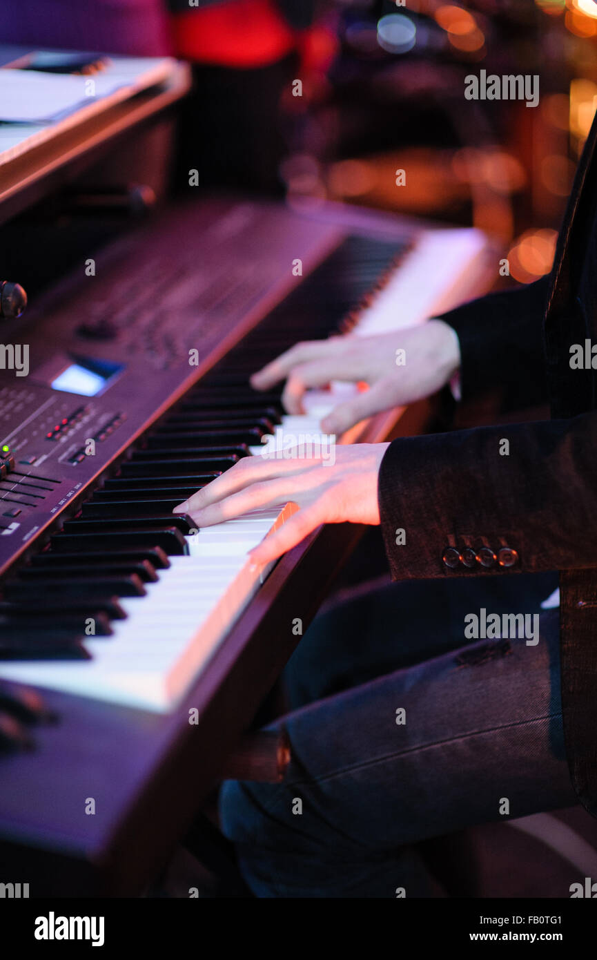 hands of musician playing keyboard in concert with shallow depth of ...