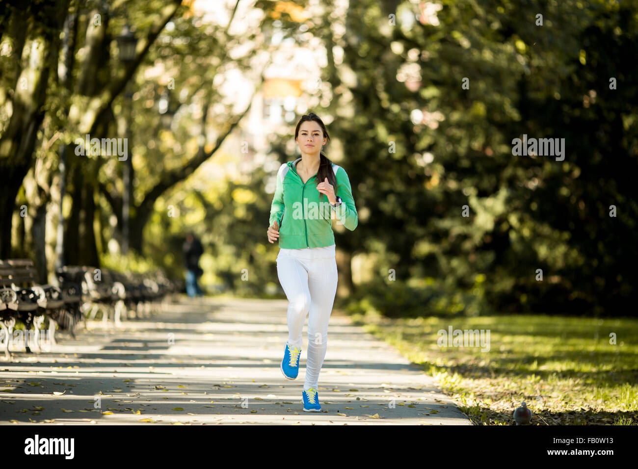 Young woman running in the park Stock Photo - Alamy