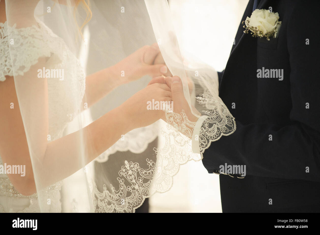 Bride and groom's hands at wedding ceremony Stock Photo - Alamy