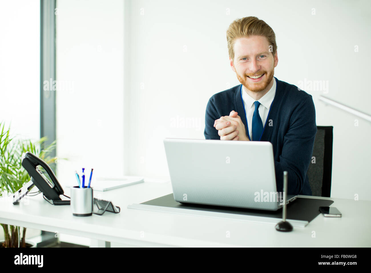 Young man working in the office Stock Photo - Alamy