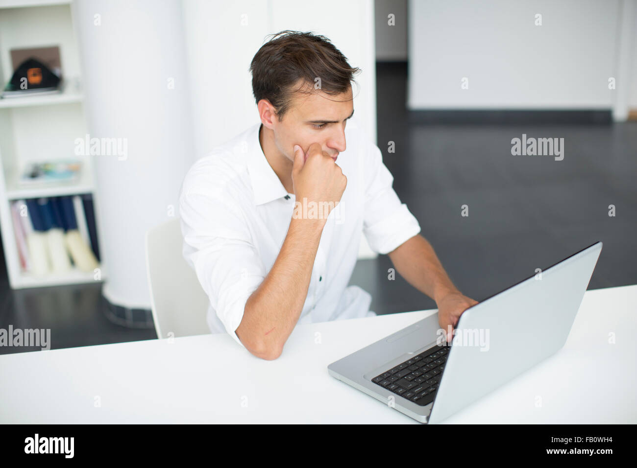 Young man in the office Stock Photo - Alamy
