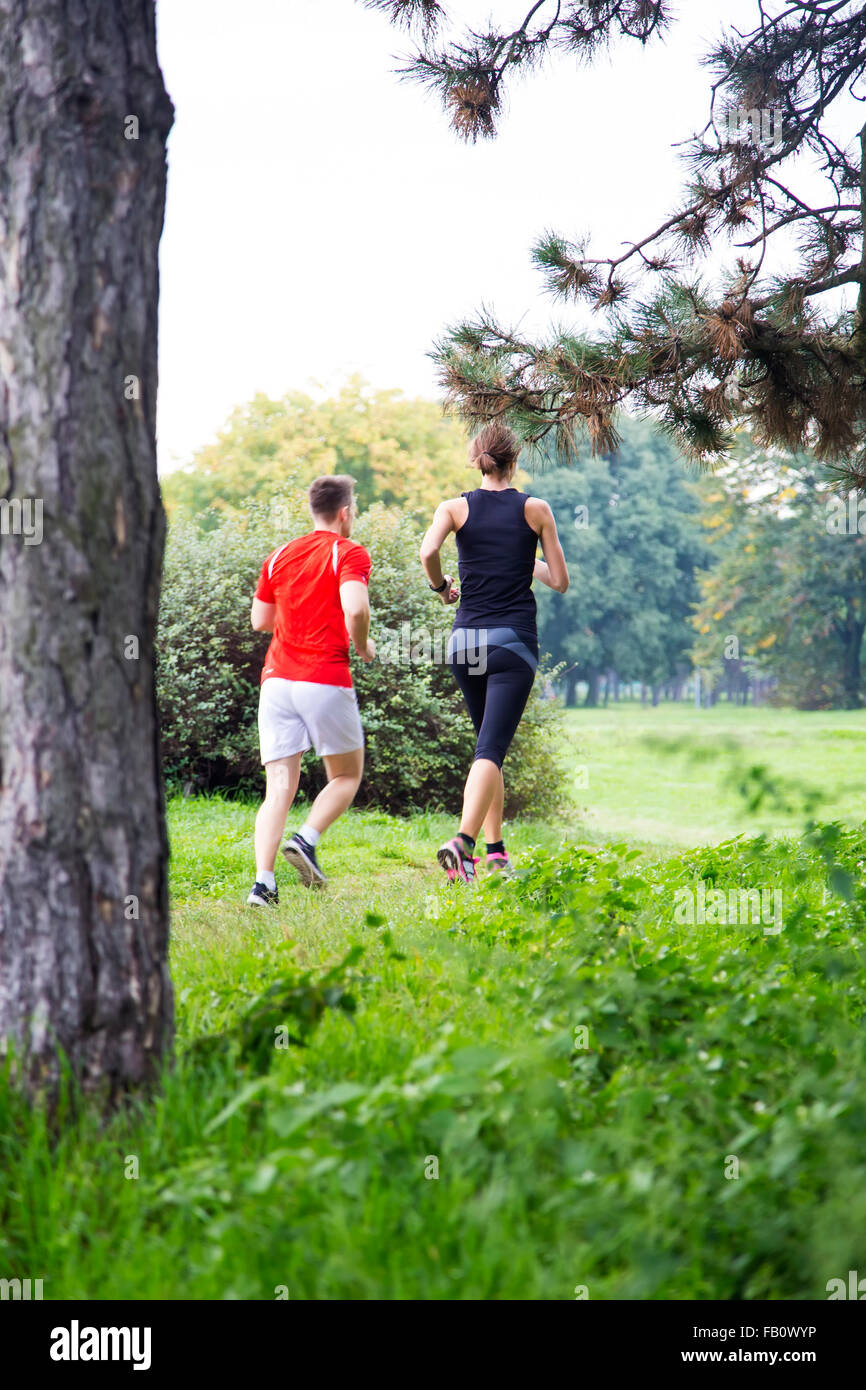 Young people running in the park Stock Photo - Alamy