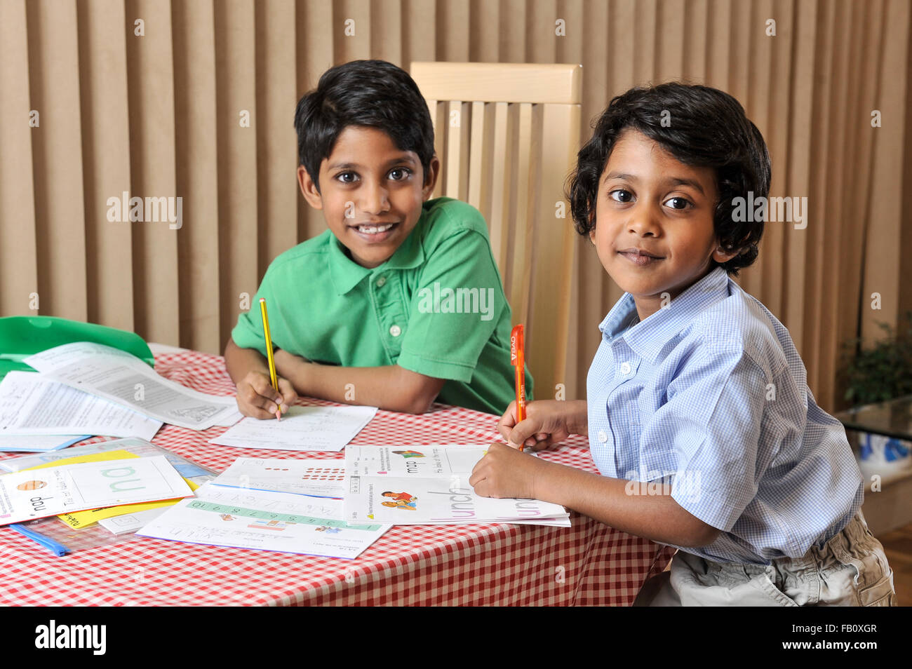 Two young boys doing their homework after school Stock Photo - Alamy