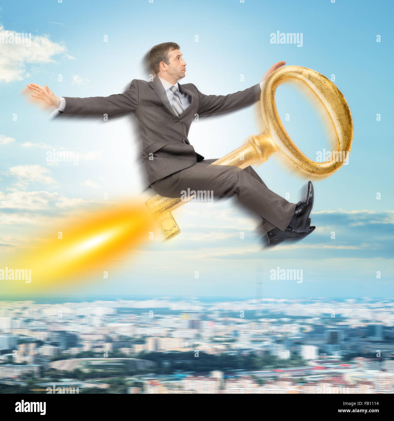 Businessman flying on key Stock Photo - Alamy