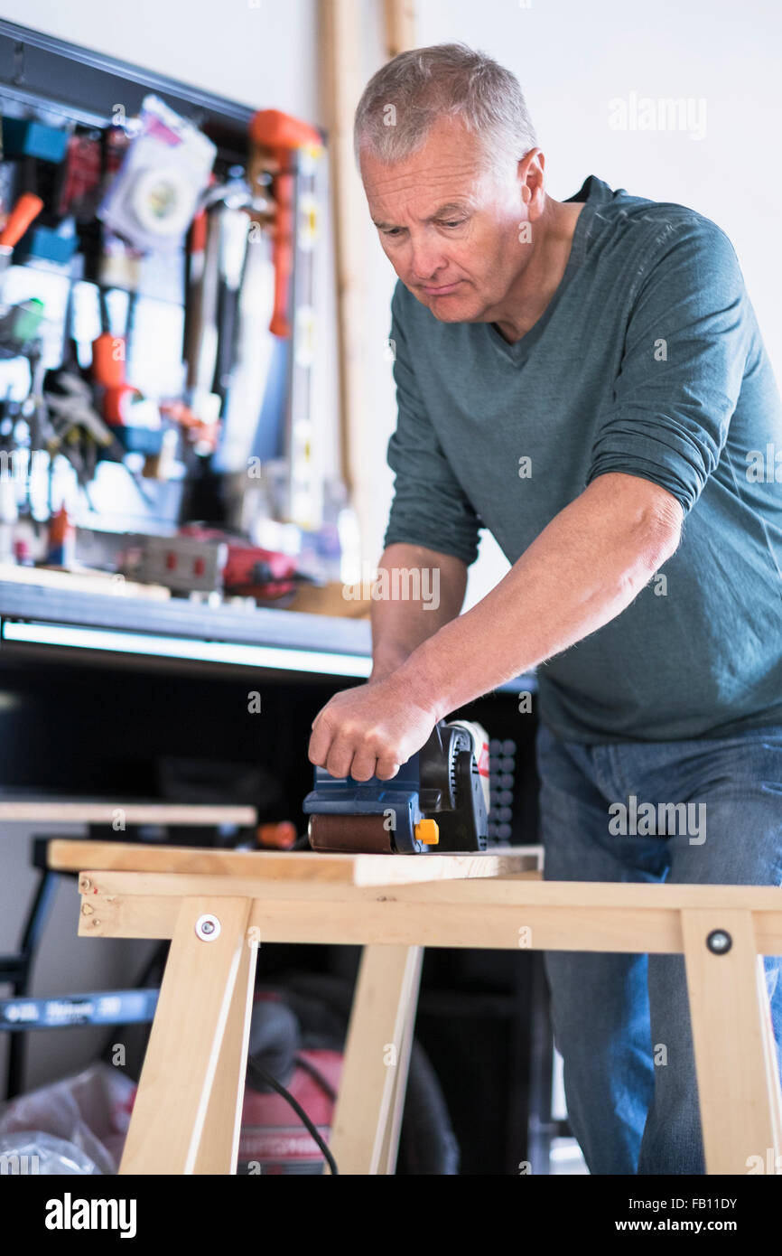 Man working with wood in home workshop Stock Photo - Alamy