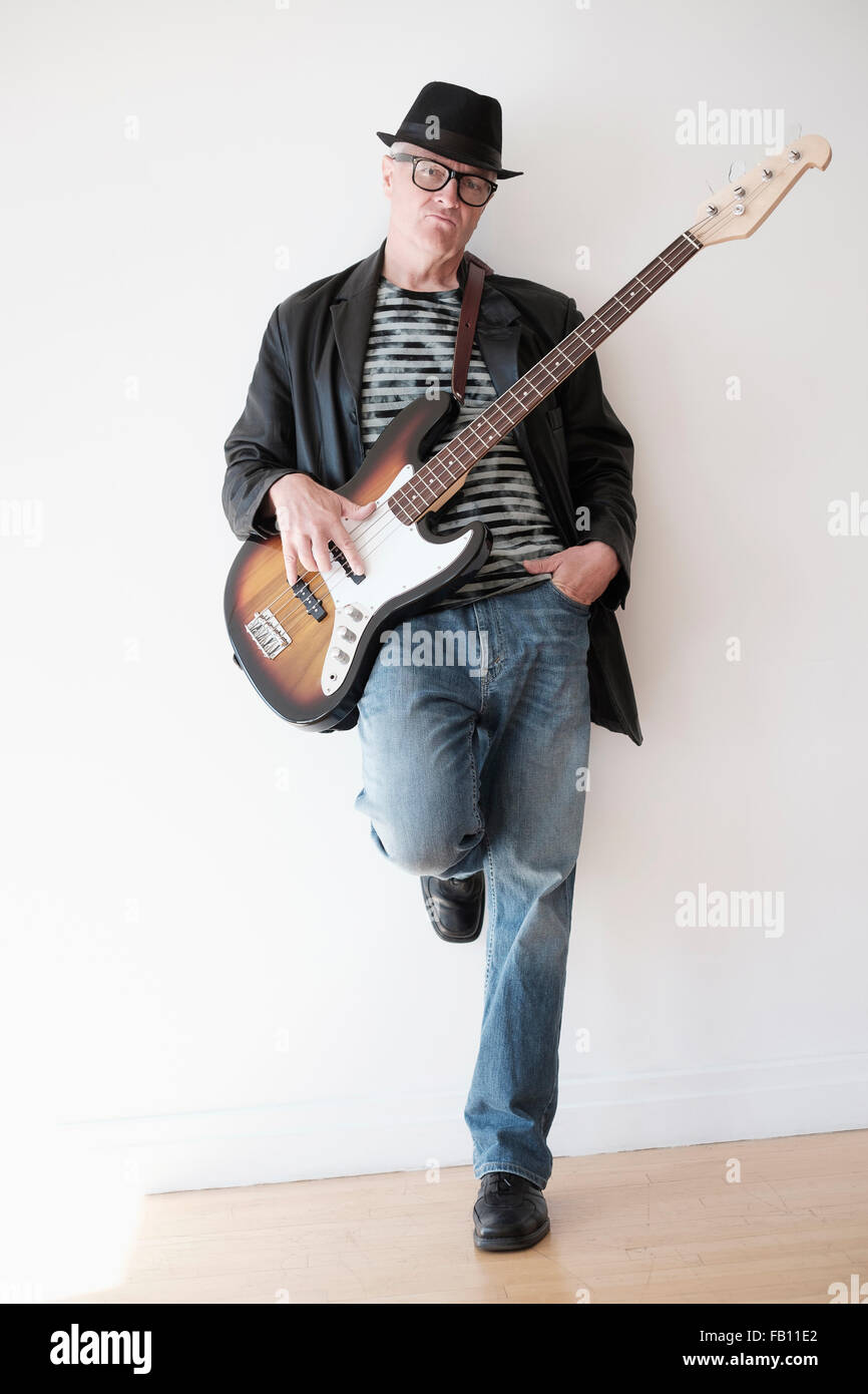 Portrait of cool man with bass guitar Stock Photo - Alamy