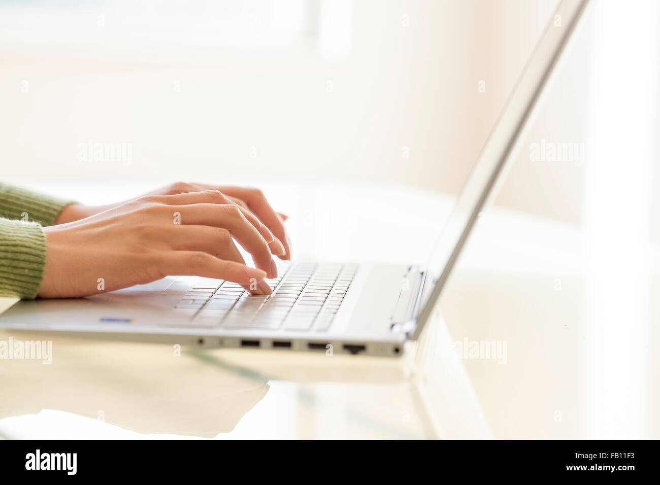 Hands typing on laptop keyboard Stock Photo - Alamy